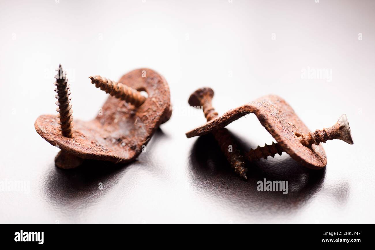 metal angle brackets with corrosive rust and damaged screws, white ...