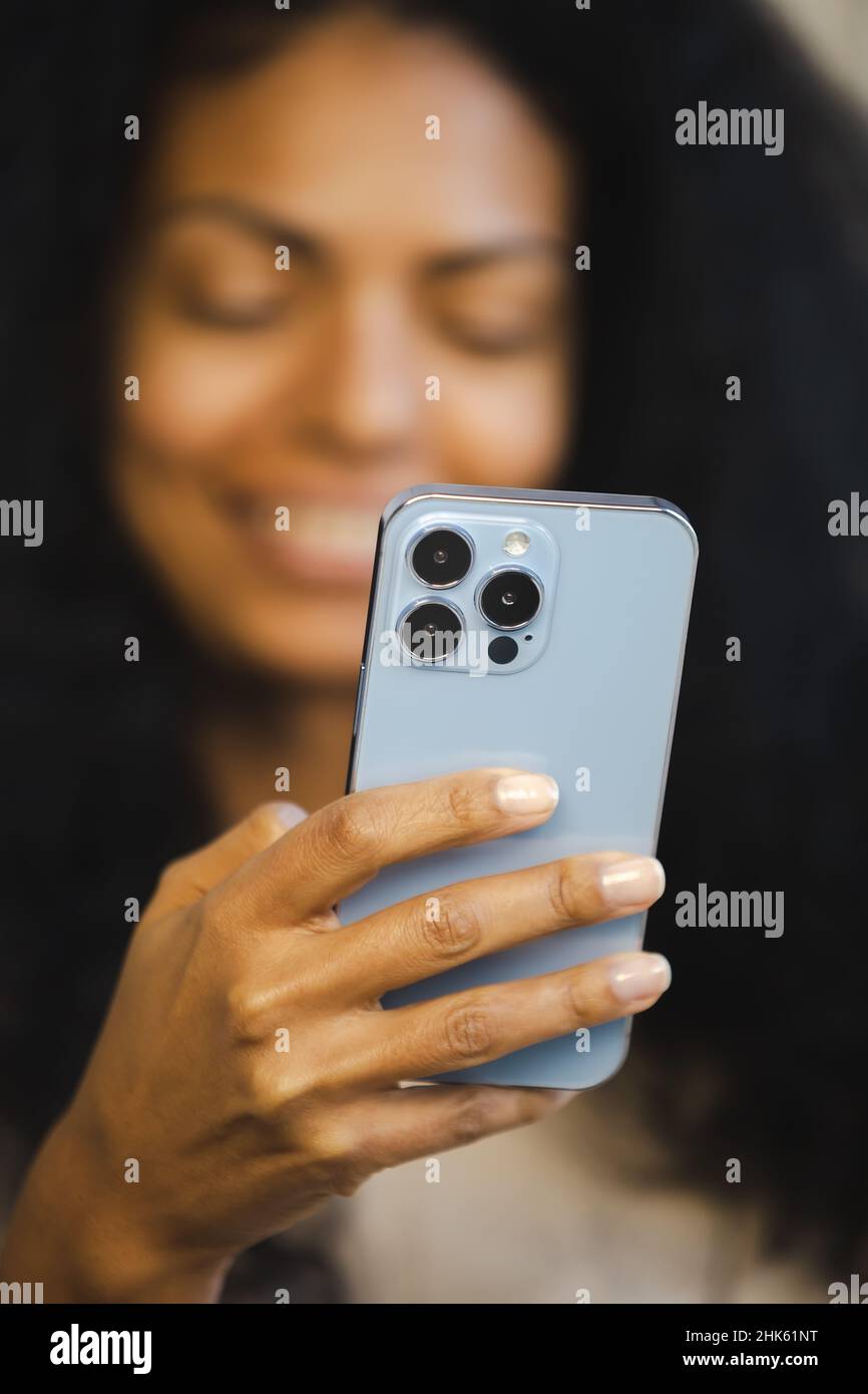 Happy black woman using mobile phone. Cheerful African female holding ...