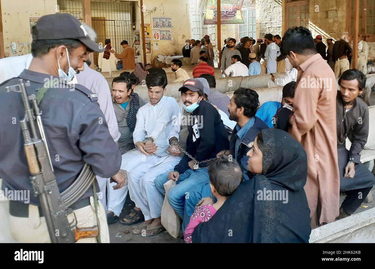 Security staffs escorting arrested suspected criminals in different ...