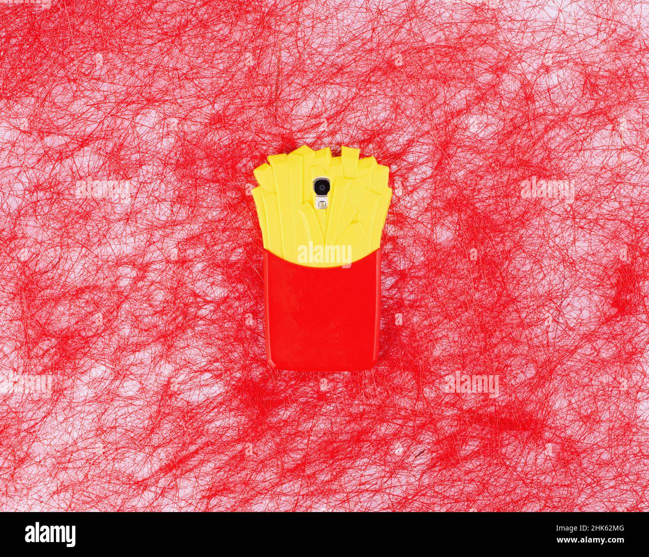 Smartphone in fun cover. Located on a red fluff background Stock Photo ...