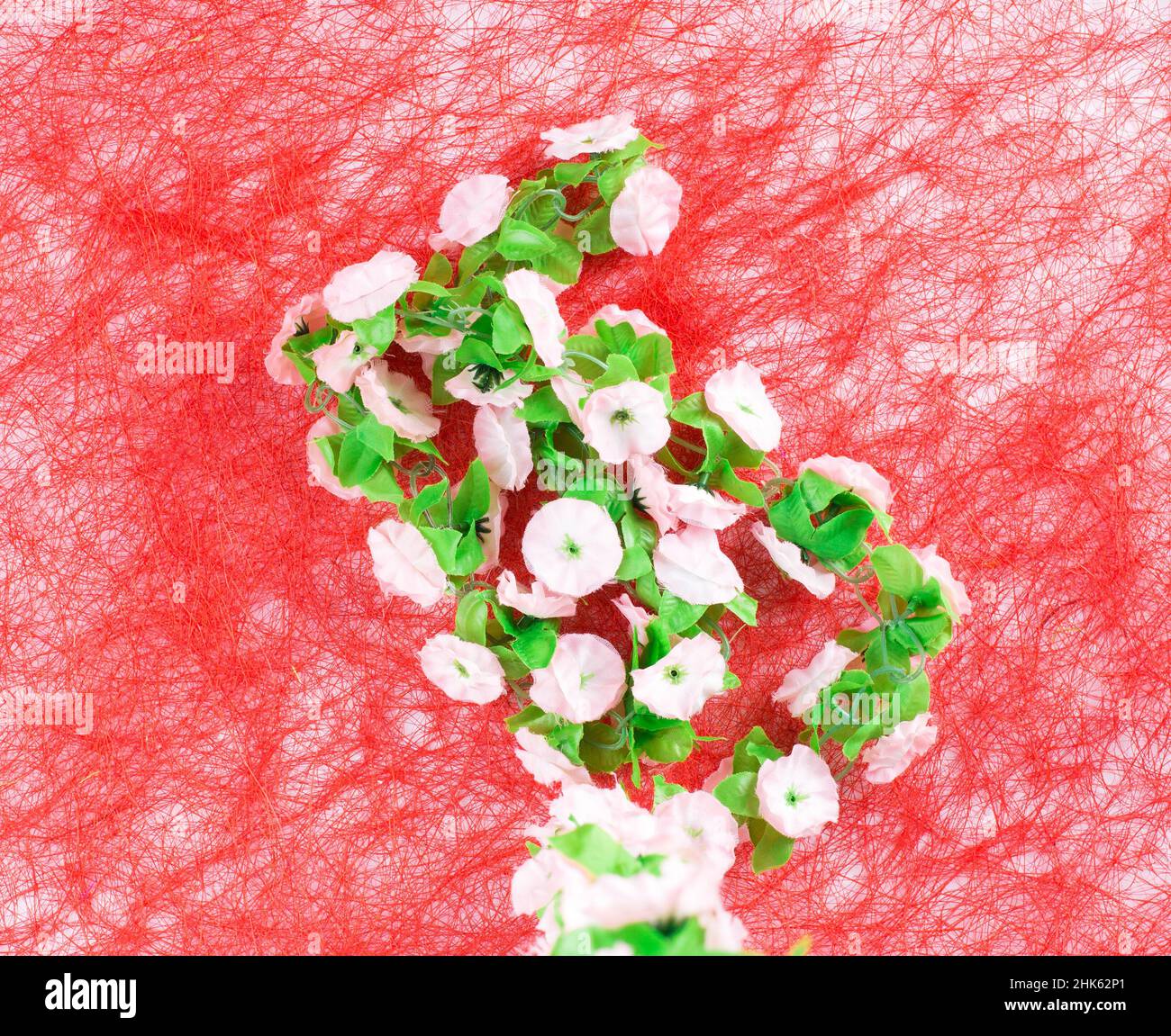 Beautiful artificial flowers. Located on a red fluff background Stock ...