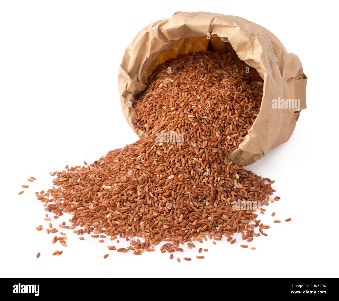 scattered whole grain dark brown rice from a paper bag, also called ...