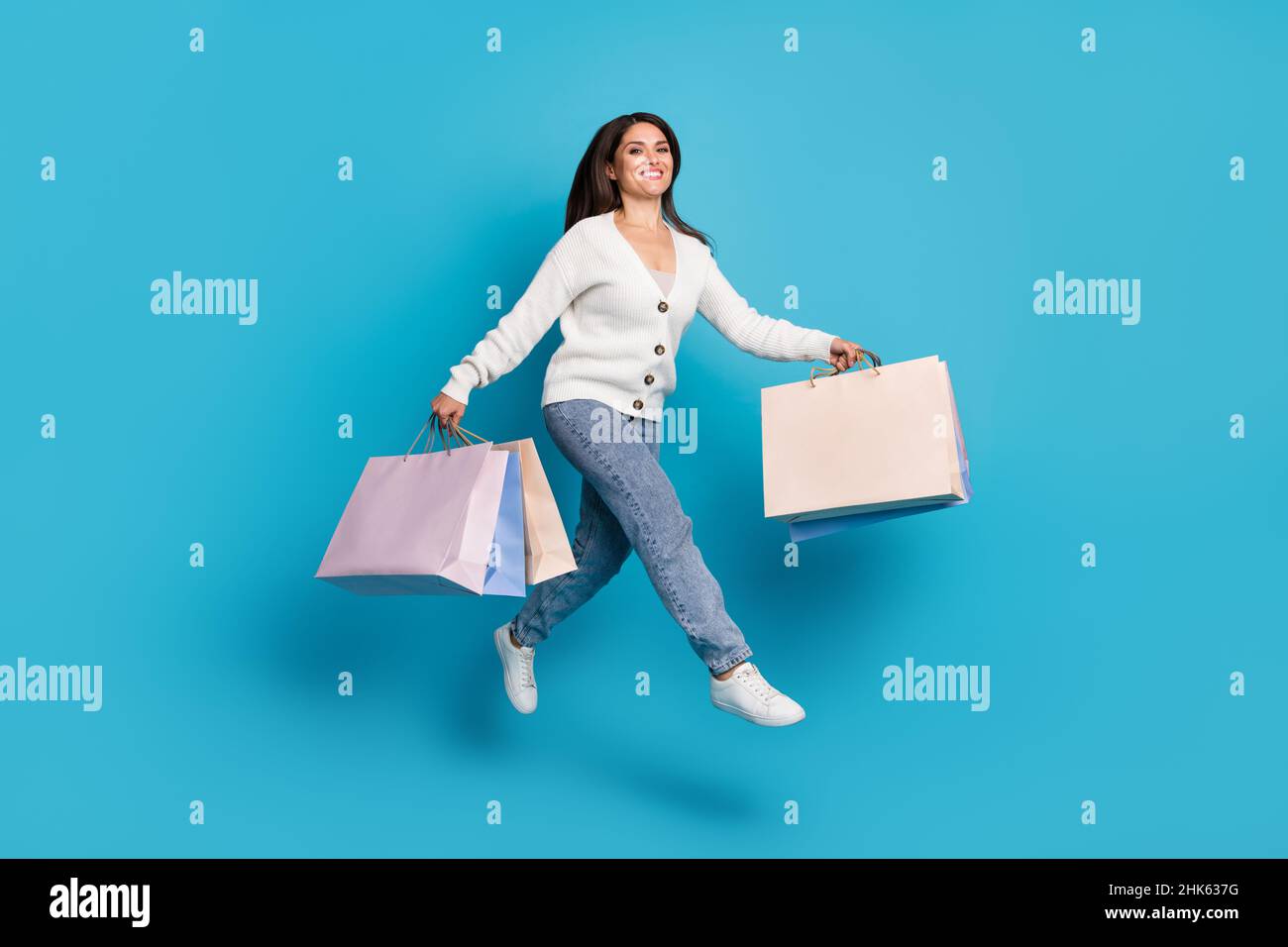 Photo of sweet cute lady dressed white cardigan carrying shoppers ...