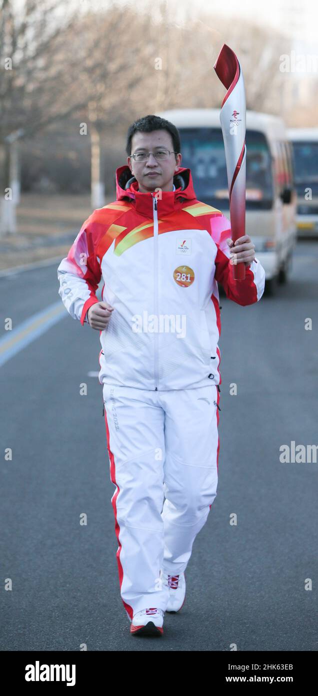 Beijing, China. 2nd Feb, 2022. Torch bearer Ji Nan runs with the torch during the Beijing 2022 ...