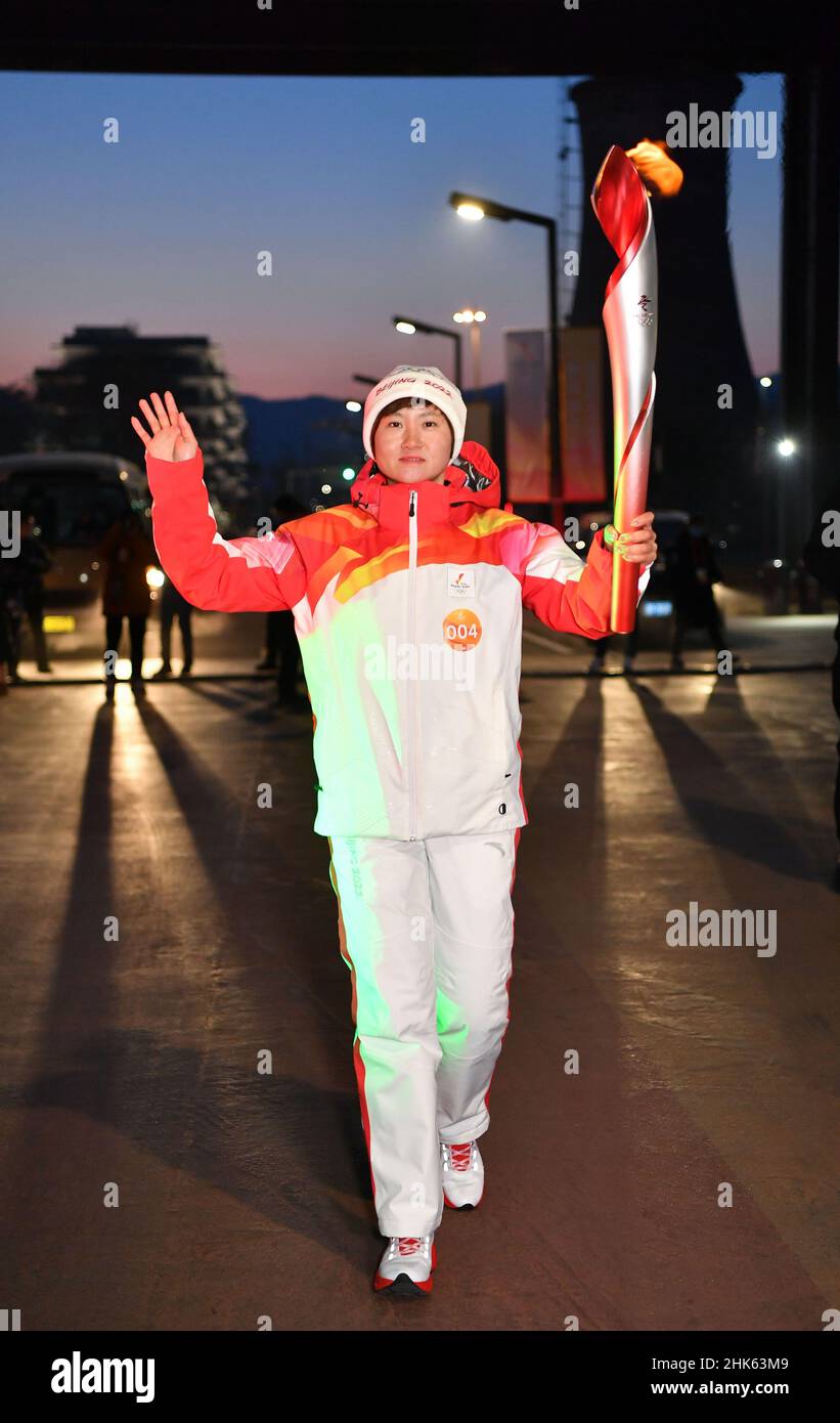 Beijing, China. 2nd Feb, 2022. Torch bearer Zhong Tianshi runs with the torch during the Beijing ...