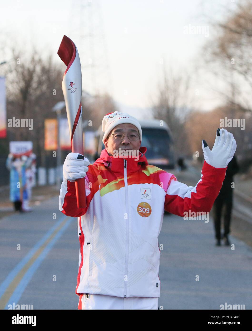 Beijing, China. 2nd Feb, 2022. Torch bearer Pu Zhongjie runs with the ...