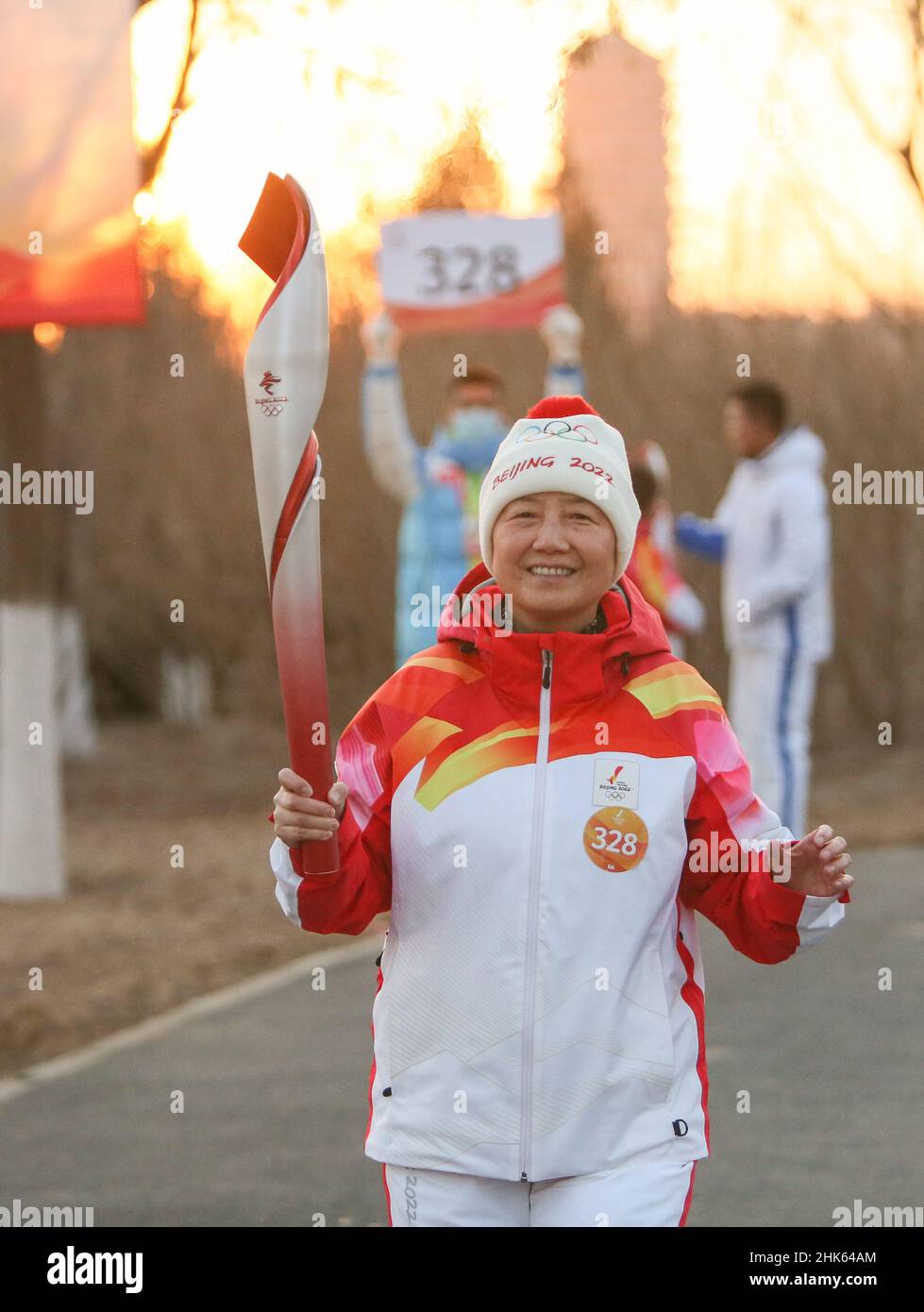 Beijing, China. 2nd Feb, 2022. Torch bearer Wang Xijuan runs with the torch during the Beijing ...