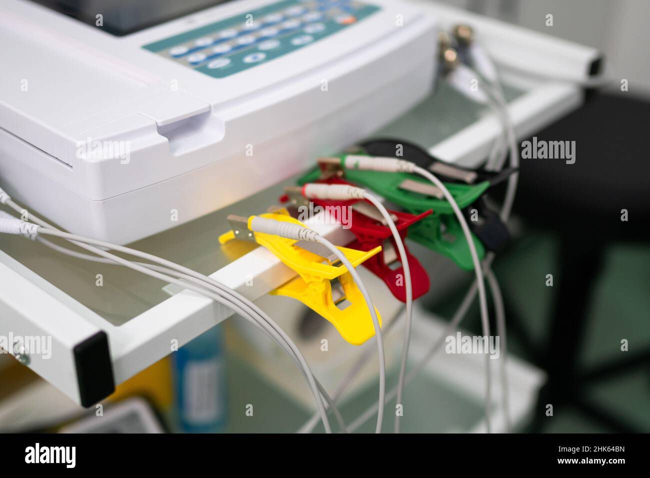 Cardiologist doctor performs electrocardiography procedure on man lying ...