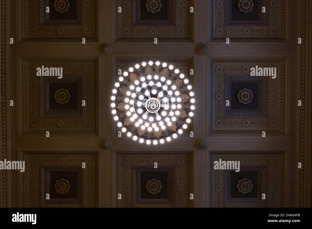 Looking up at the ceiling with beautiful chandelier and decorative ...
