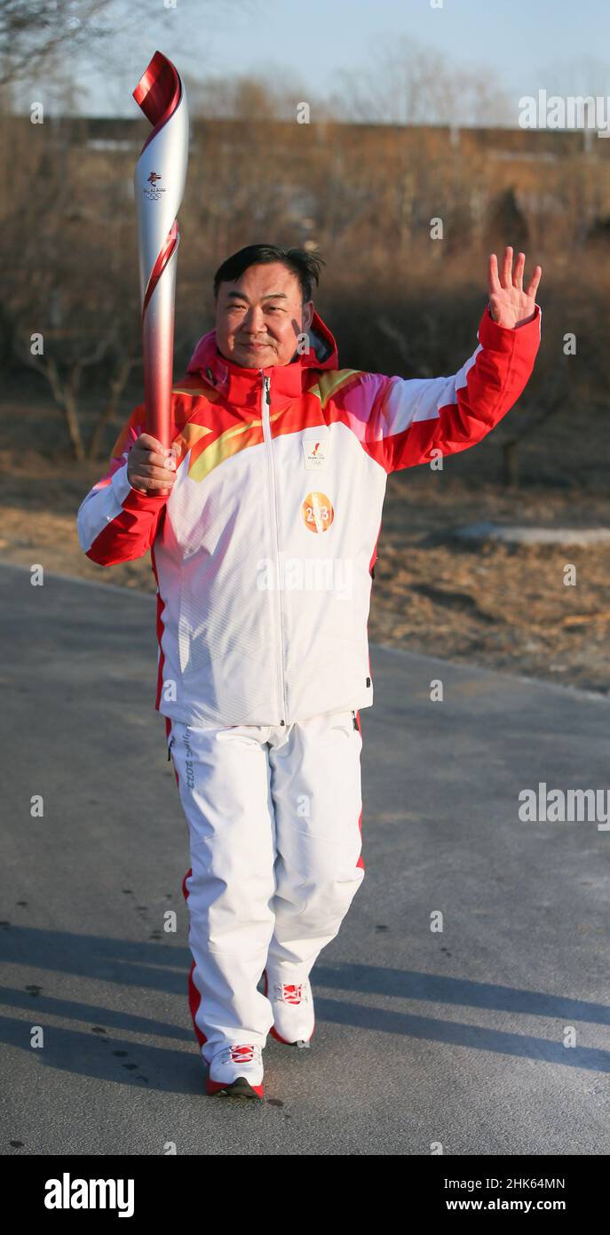 Beijing, China. 2nd Feb, 2022. Torch bearer Li Shengli runs with the torch during the Beijing ...