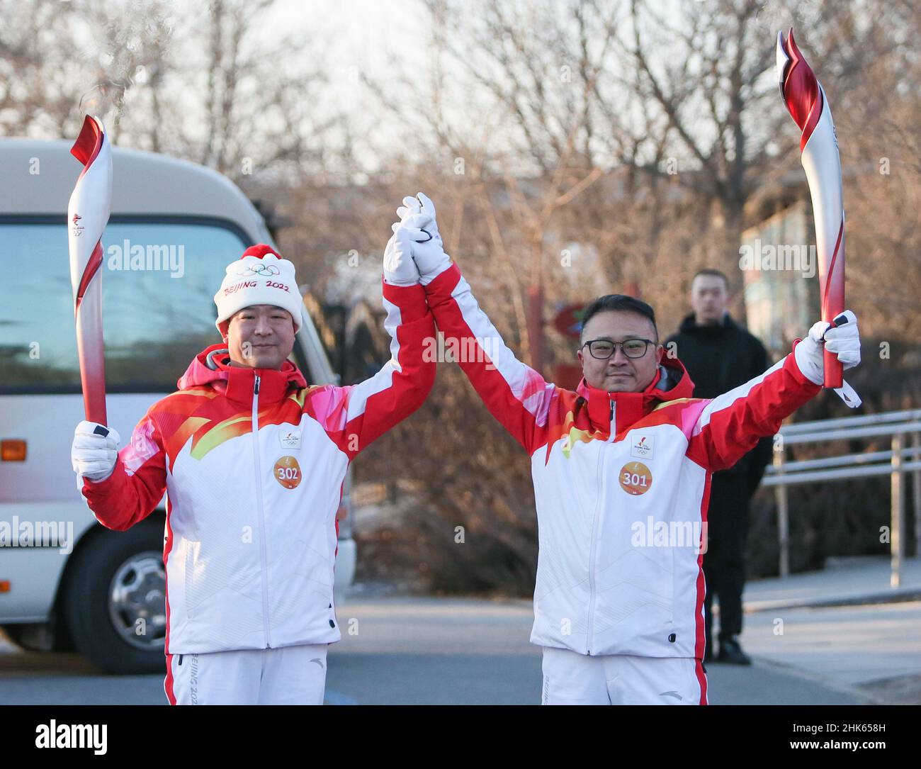 Beijing, China. 2nd Feb, 2022. Torch bearers Liu Jianfeng (R) and Liu Jinbo attend the Beijing ...