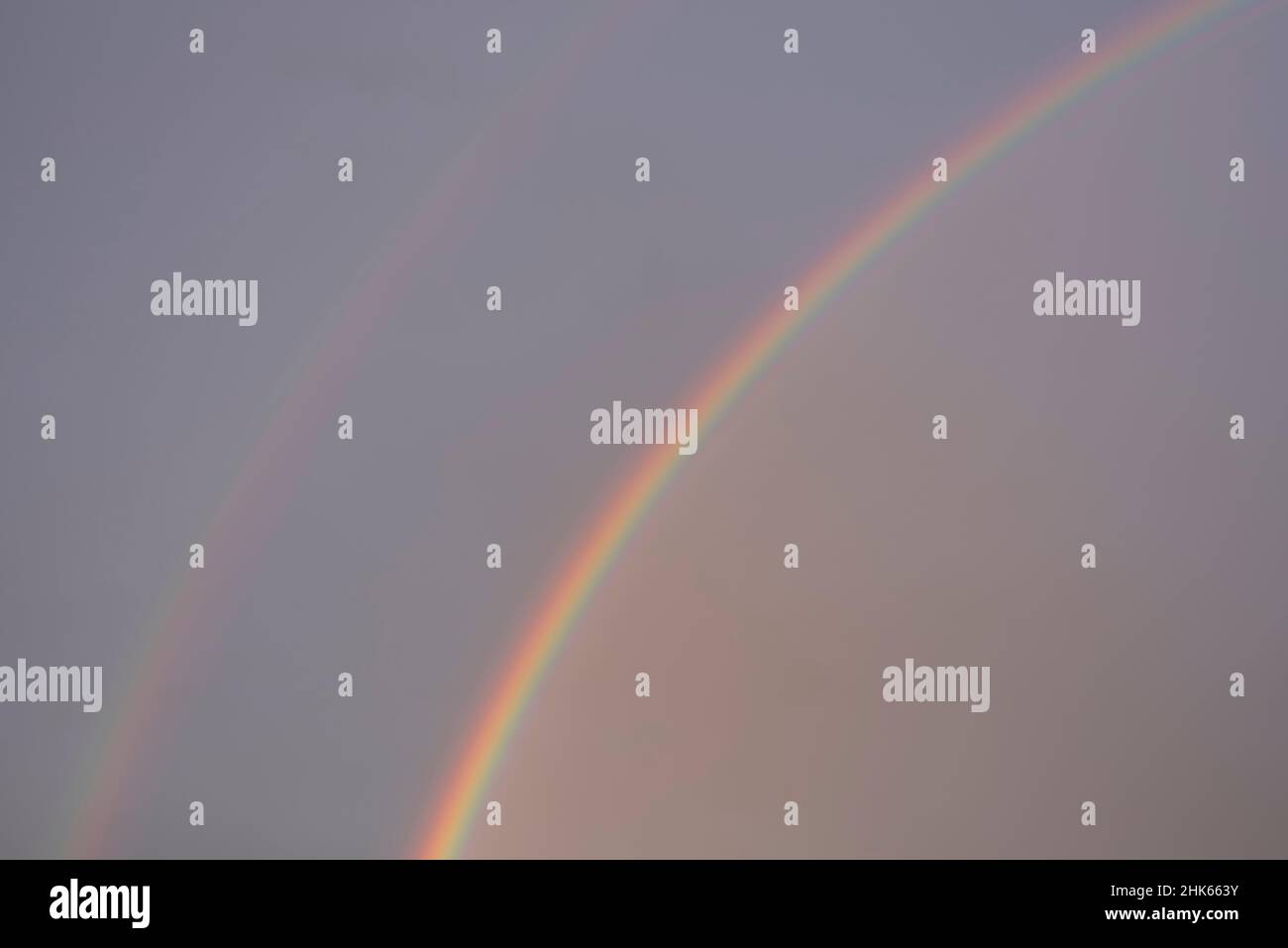a double rainbow with spectral colors in a gray sky Stock Photo - Alamy