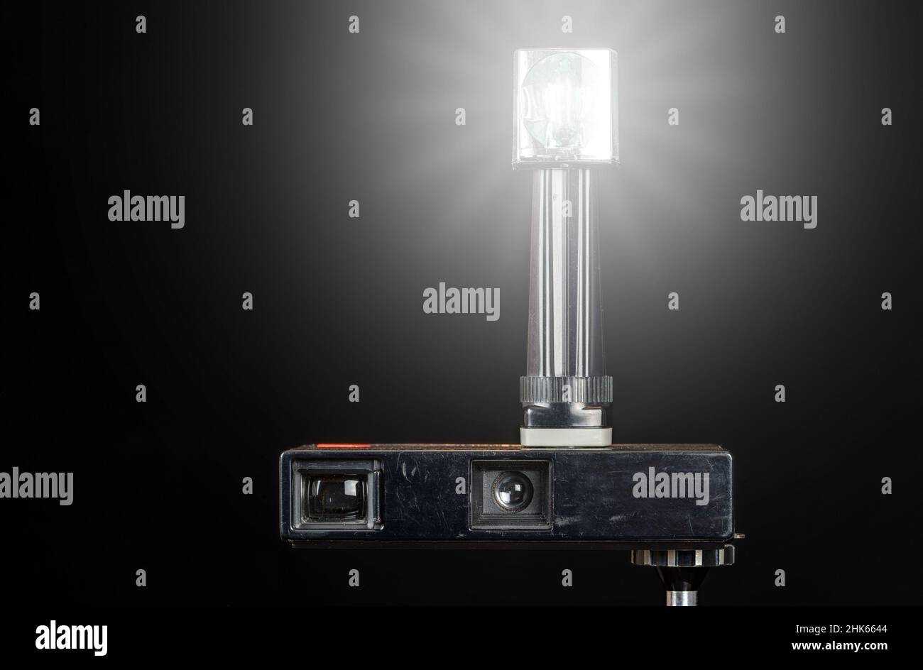 Old, dusty, analog pocket camera that triggers a flash with a flash ...