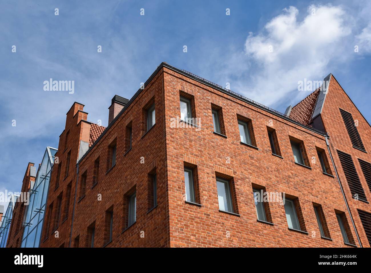 Red brick wall with windows against blue sky Stock Photo - Alamy