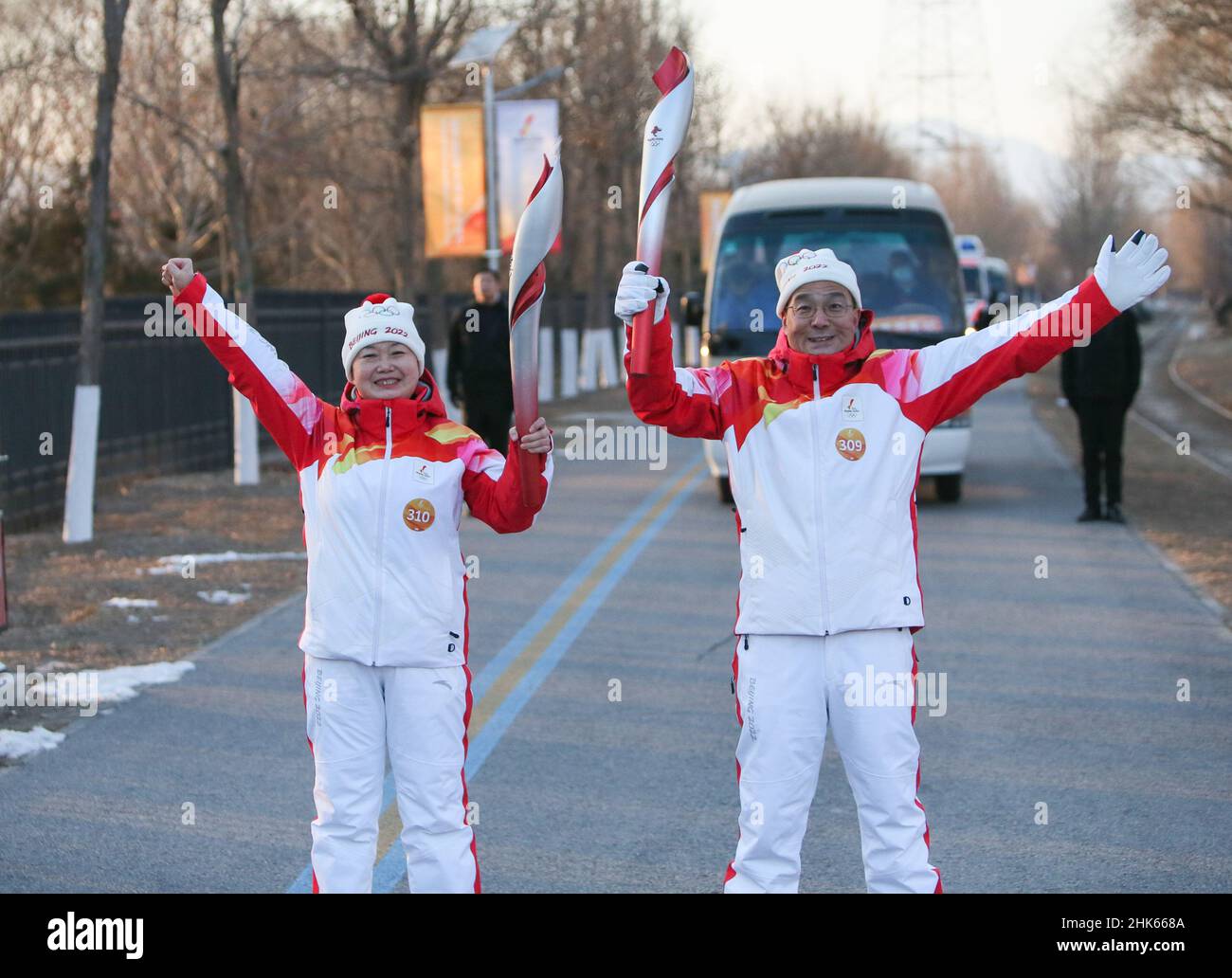 Beijing, China. 2nd Feb, 2022. Torch bearers Qu Liang (L) and Pu ...