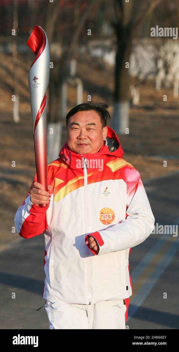 Beijing, China. 2nd Feb, 2022. Torch bearer Li Shengli runs with the torch during the Beijing ...