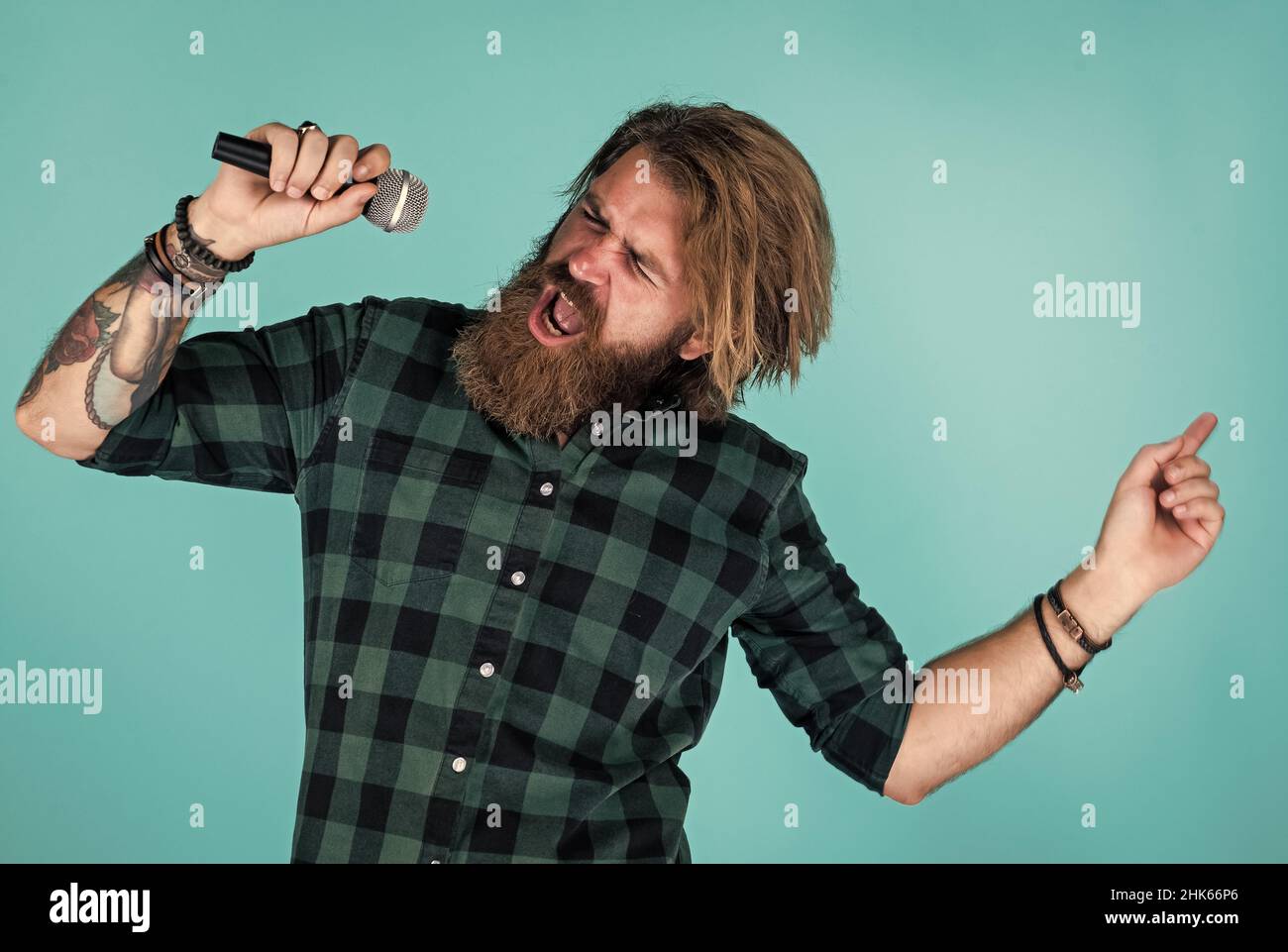 male singer with microphone. karaoke concept. bearded man in checkered ...