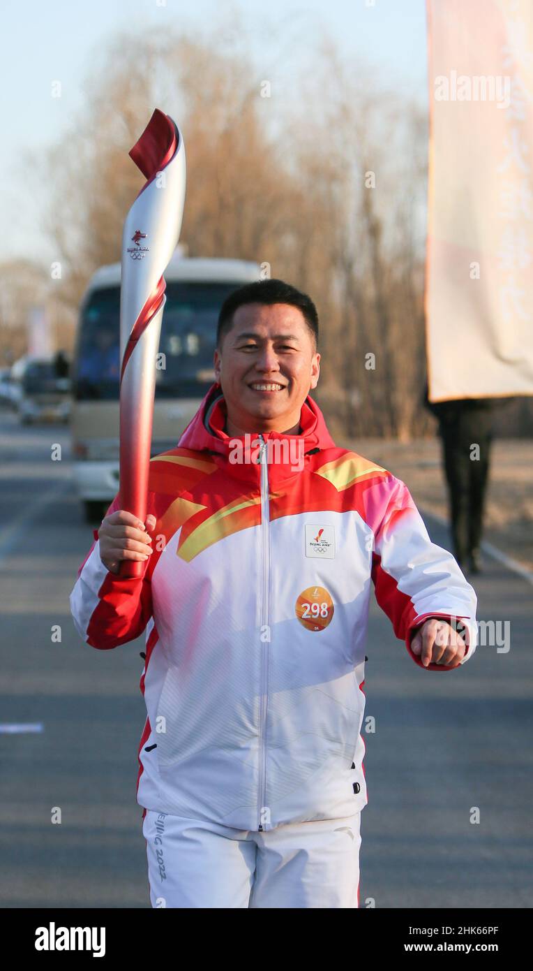 Beijing, China. 2nd Feb, 2022. Torch bearer Li Zhi runs with the torch during the Beijing 2022 ...