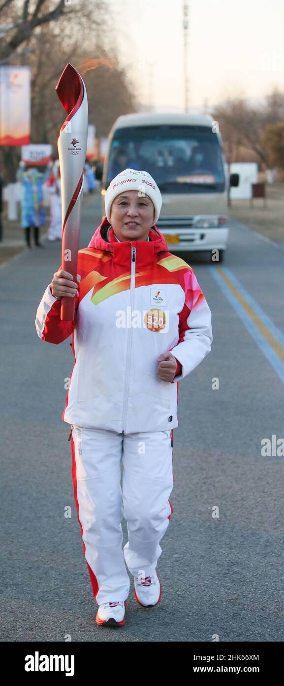 Beijing, China. 2nd Feb, 2022. Torch bearer Wang Jie runs with the torch during the Beijing 2022 ...