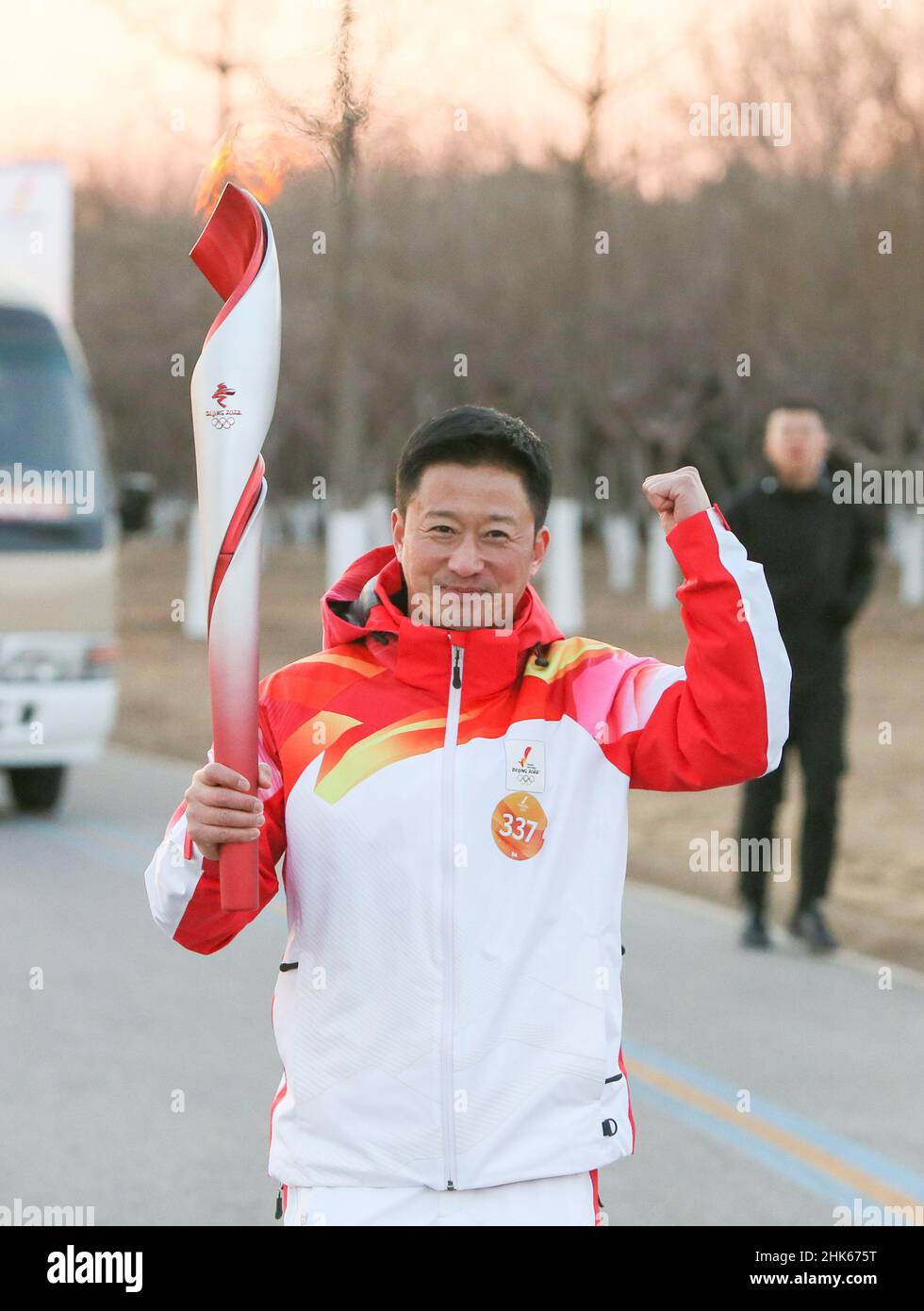 Beijing, China. 2nd Feb, 2022. Torch bearer Wu Jing runs with the torch ...