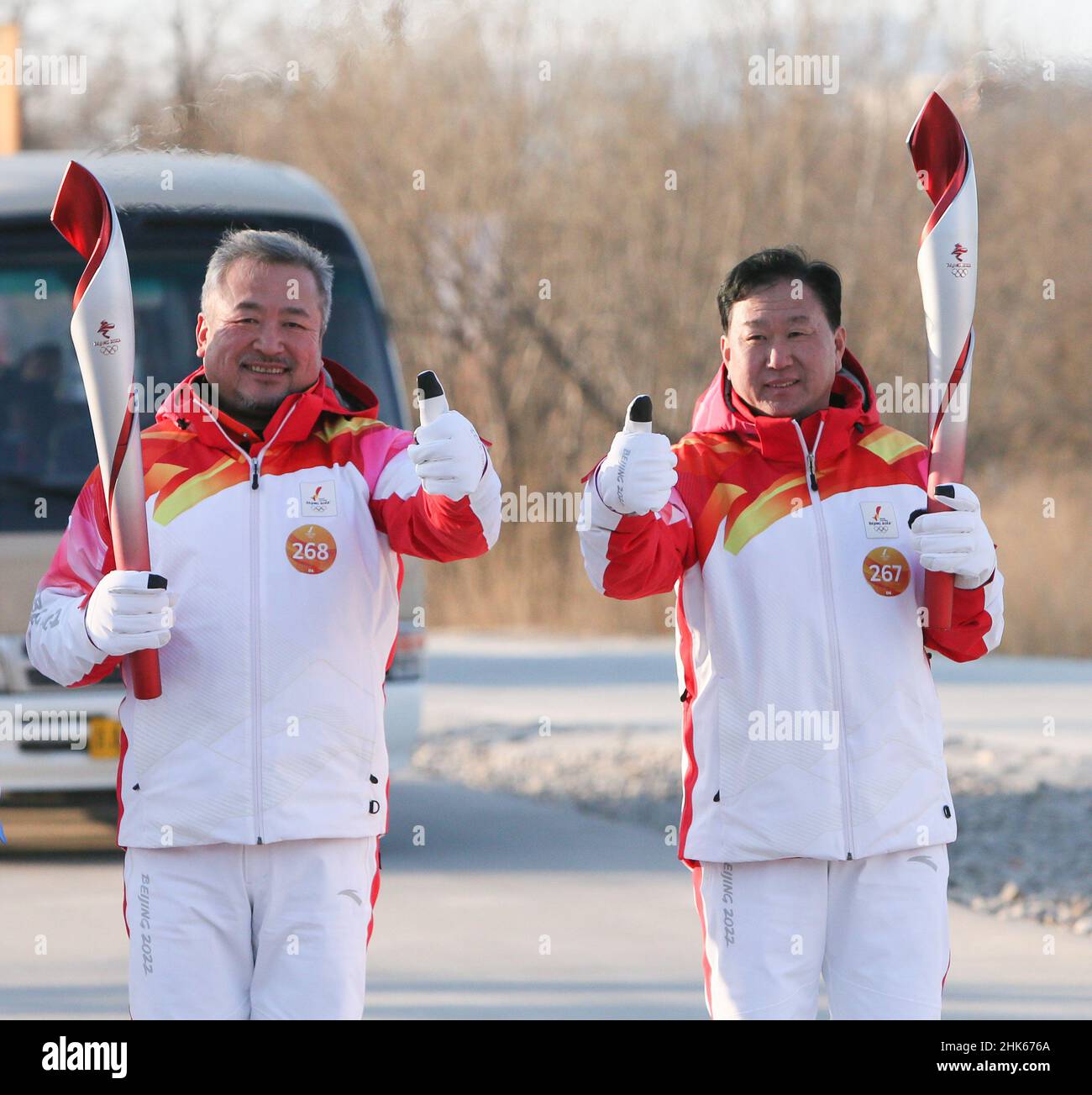 Beijing, China. 2nd Feb, 2022. Torch bearers Duan Xiaolong (R) and Fan ...