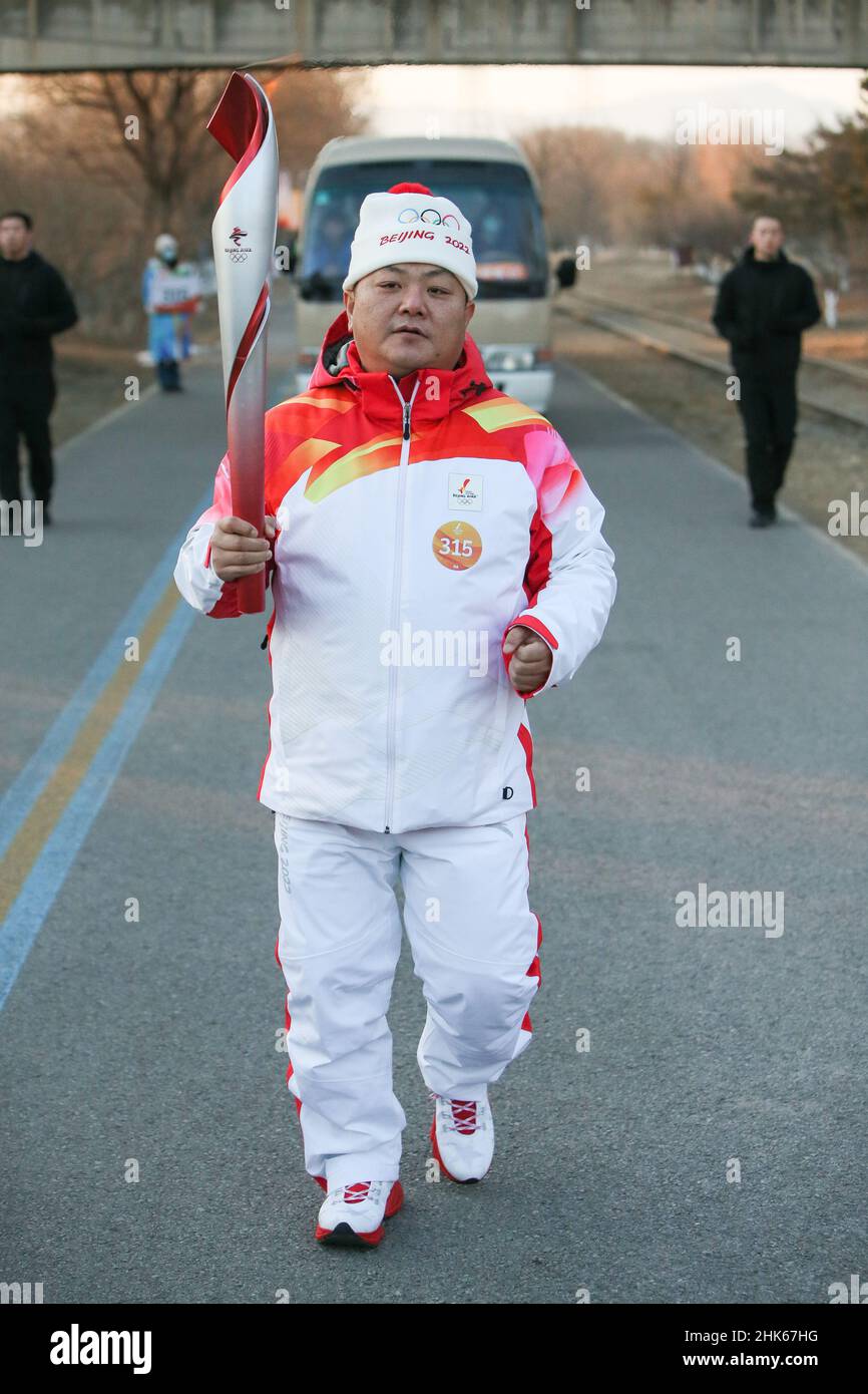Beijing, China. 2nd Feb, 2022. Torch bearer Shi Zhongfeng runs with the ...