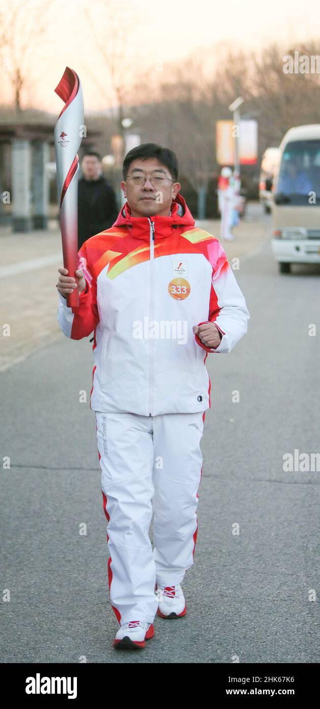 Beijing, China. 2nd Feb, 2022. Torch bearer Wu Jiaxi runs with the torch during the Beijing 2022 ...