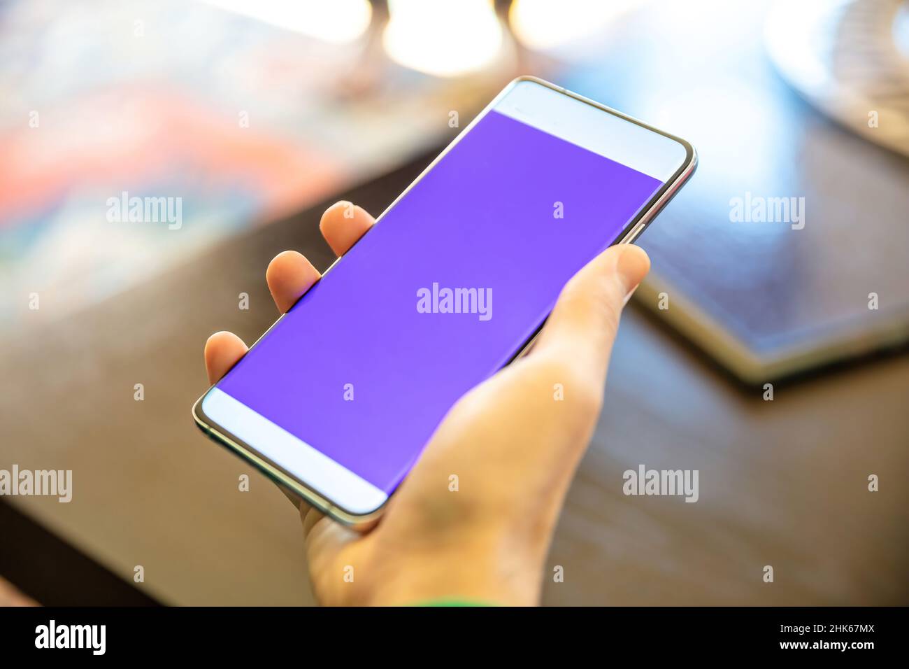 Blank screen smartphone on a male right hand, closeup. Man hold mobile ...