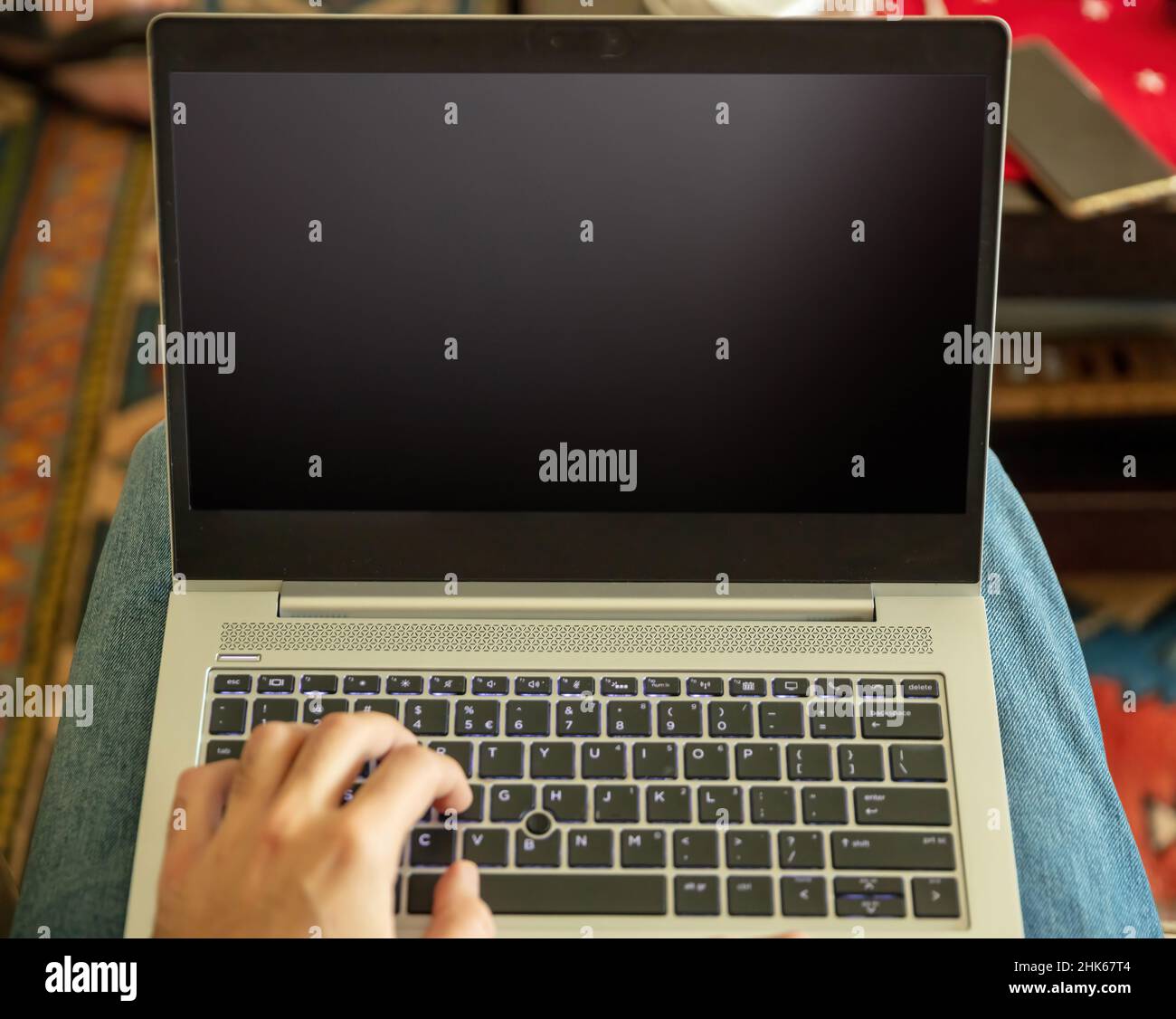 Home office work. Empty blank screen, male hand typing on a laptop ...