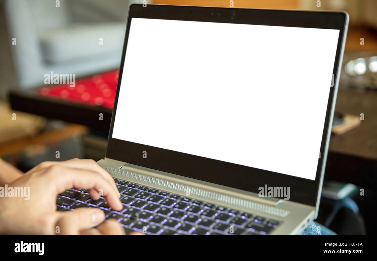 Home office work. Empty blank screen, male hand typing on a laptop ...
