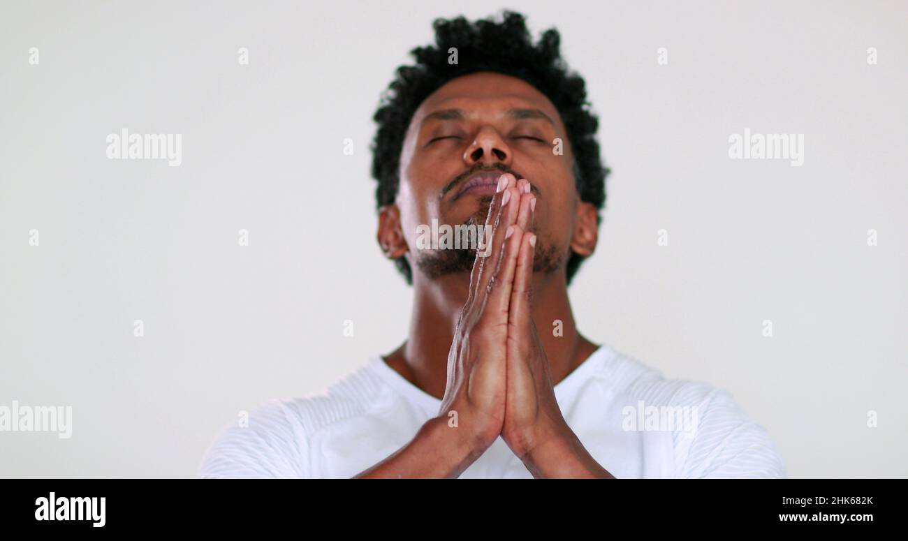 Black African man praying looking up to the sky with hope and faith ...