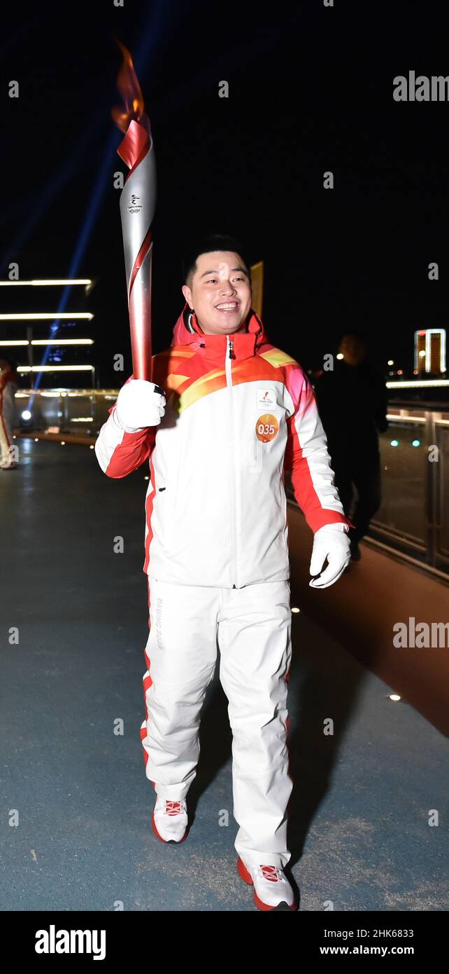 Beijing, China. 2nd Feb, 2022. Torch bearer Han Xiaonan runs with the torch during the Beijing ...