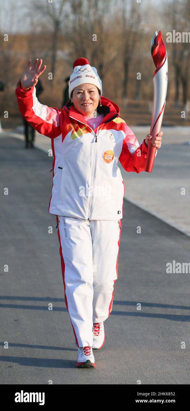 Beijing, China. 2nd Feb, 2022. Torch bearer Li Xiuping runs with the torch during the Beijing ...