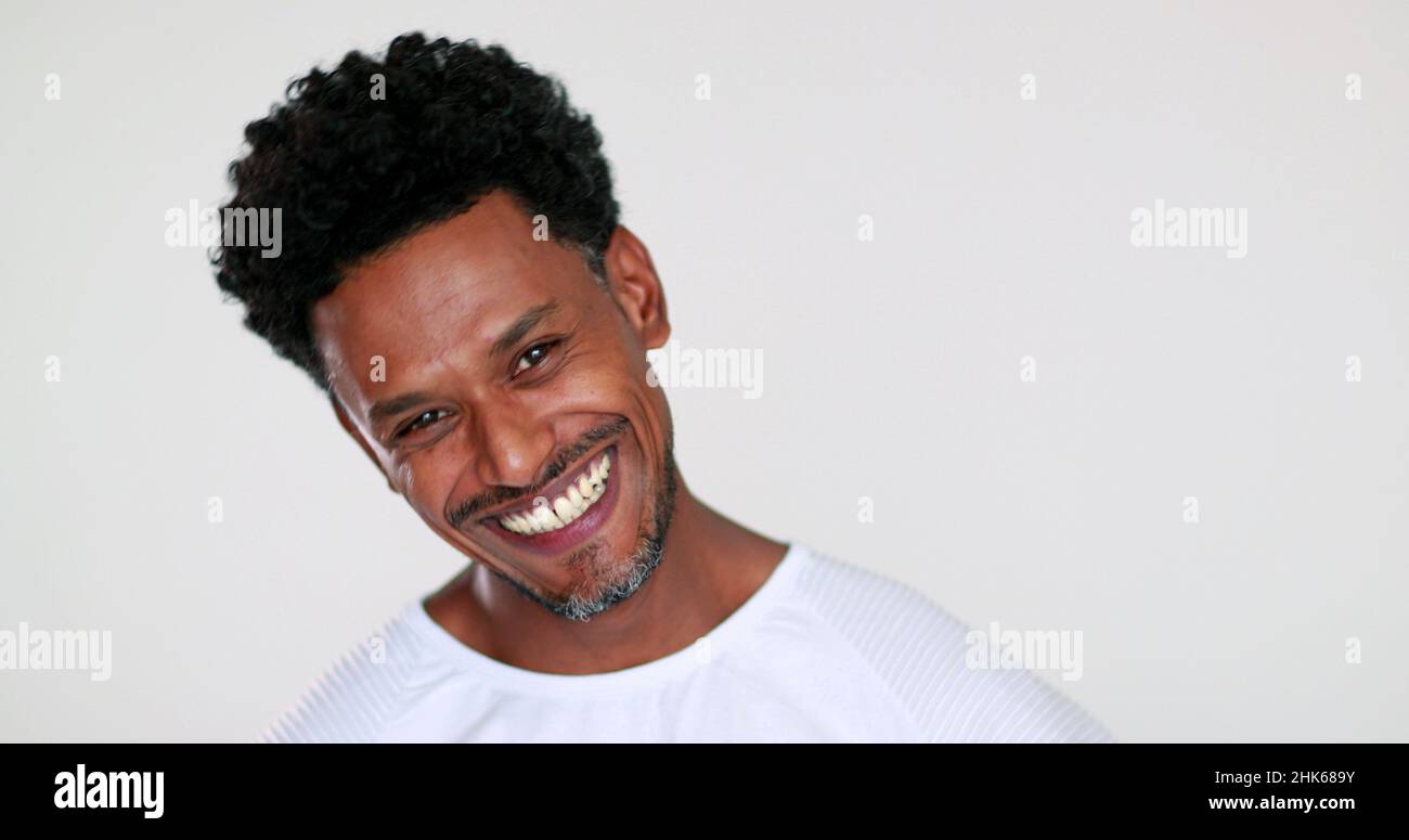 Casual American man feeling relaxed smiling, real life laugh and smile ...