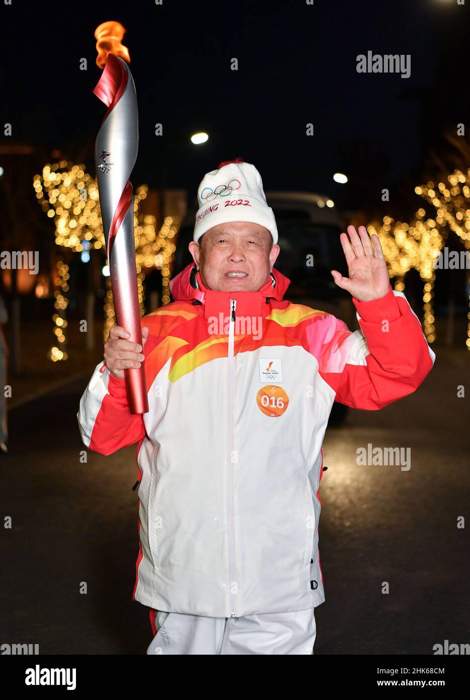 Beijing, China. 2nd Feb, 2022. Torch bearer Li Yu runs with the torch during the Beijing 2022 ...