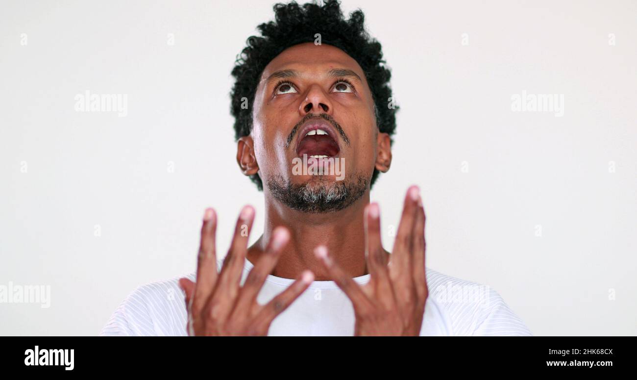 Frustrated anxious african man portrait emotional reaction, looking at ...