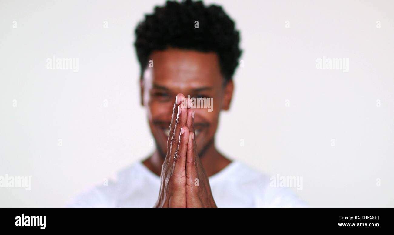 Grateful African man portrait giving thanks, faith gesture with hands ...