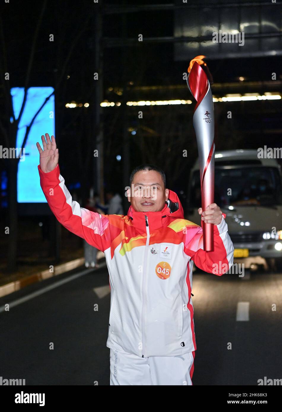 Beijing, China. 2nd Feb, 2022. Torch bearer Qiu Junqing runs with the torch during the Beijing ...