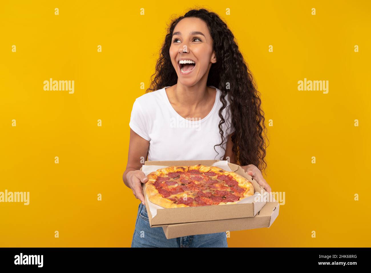 Young woman holding pizza model hi-res stock photography and images - Alamy
