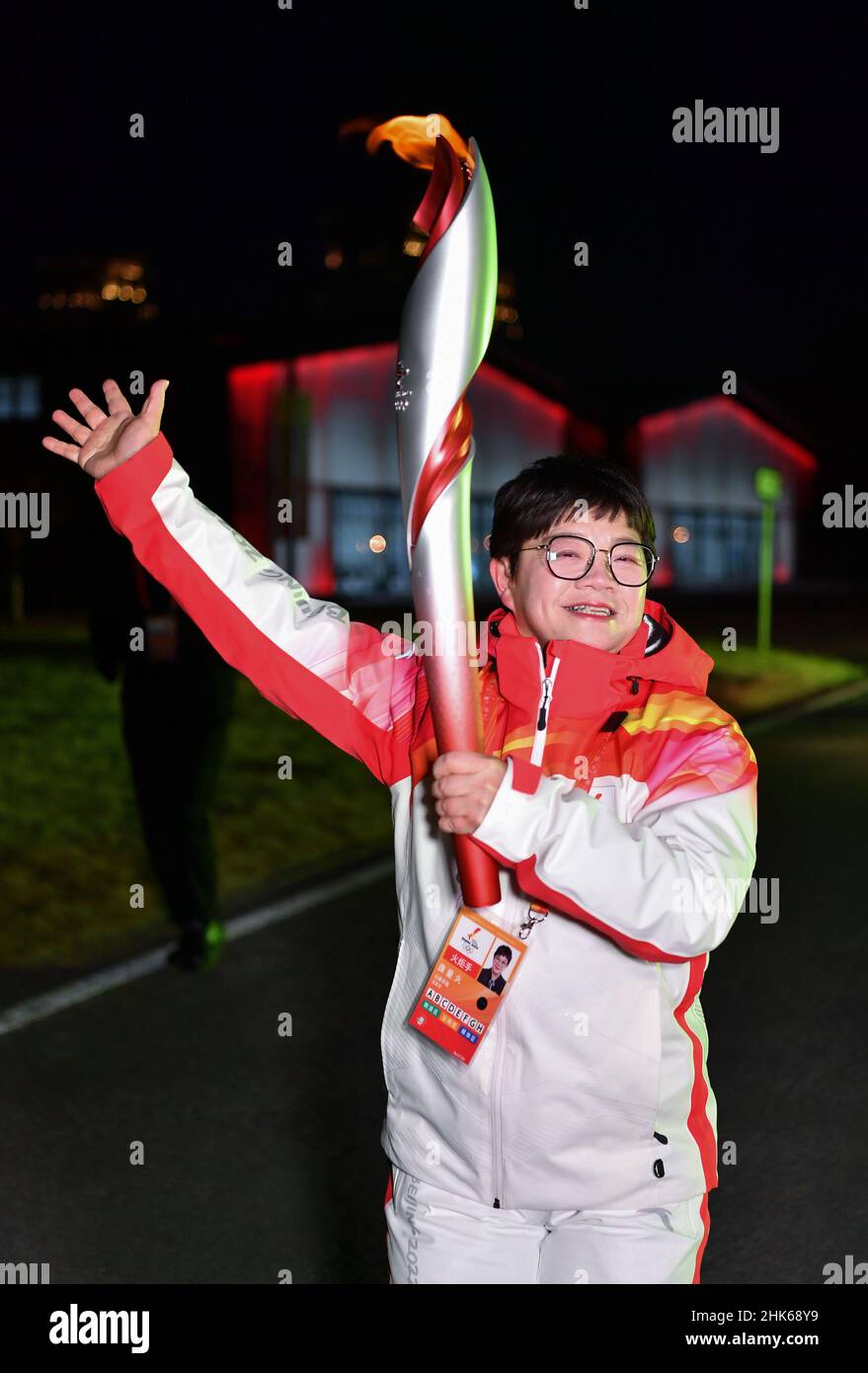 Beijing, China. 2nd Feb, 2022. Torch bearer Pang Xinghuo runs with the torch during the Beijing ...