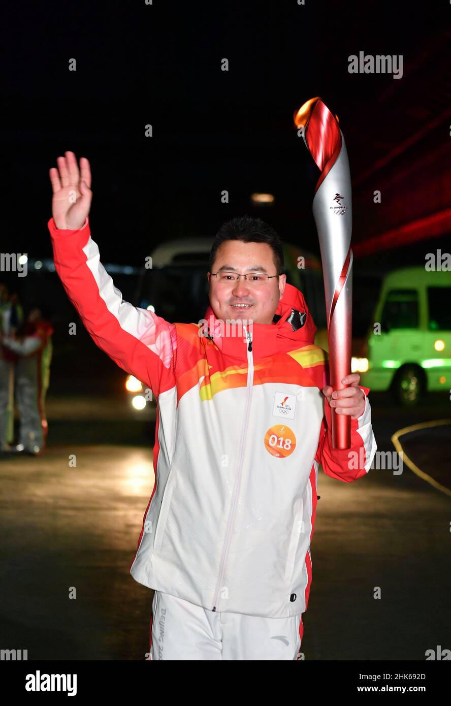 Beijing, China. 2nd Feb, 2022. Torch bearer Bo Xianglong runs with the torch during the Beijing ...