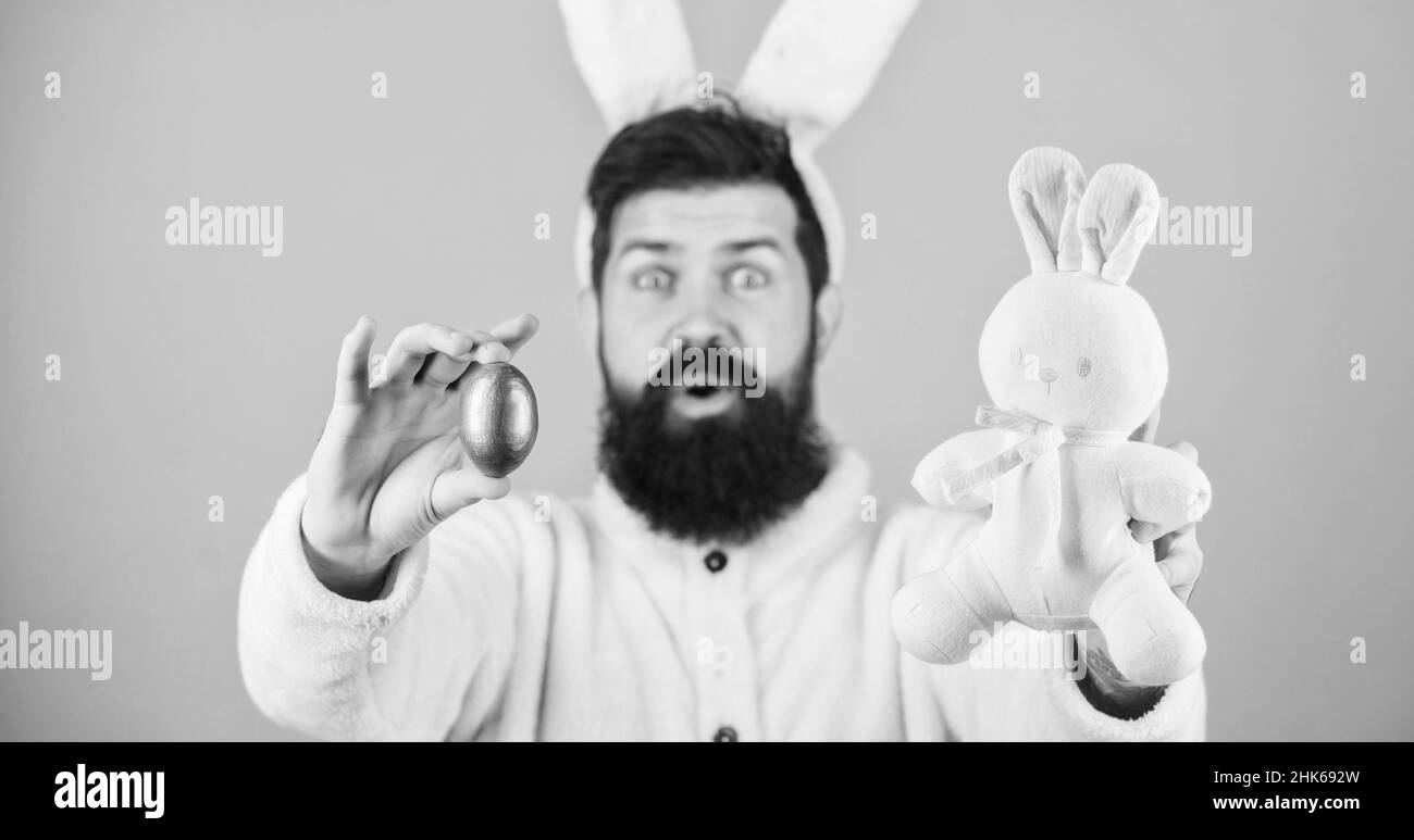 My precious. Funny bunny with beard and mustache hold pink egg. Easter ...