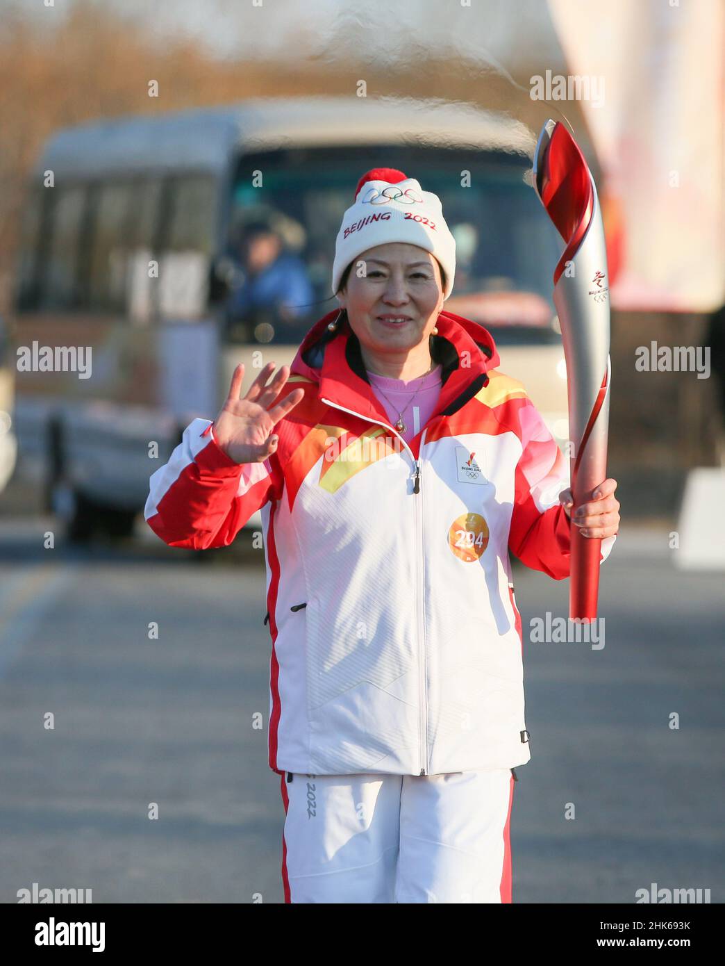 Beijing, China. 2nd Feb, 2022. Torch bearer Li Xiuping runs with the torch during the Beijing ...