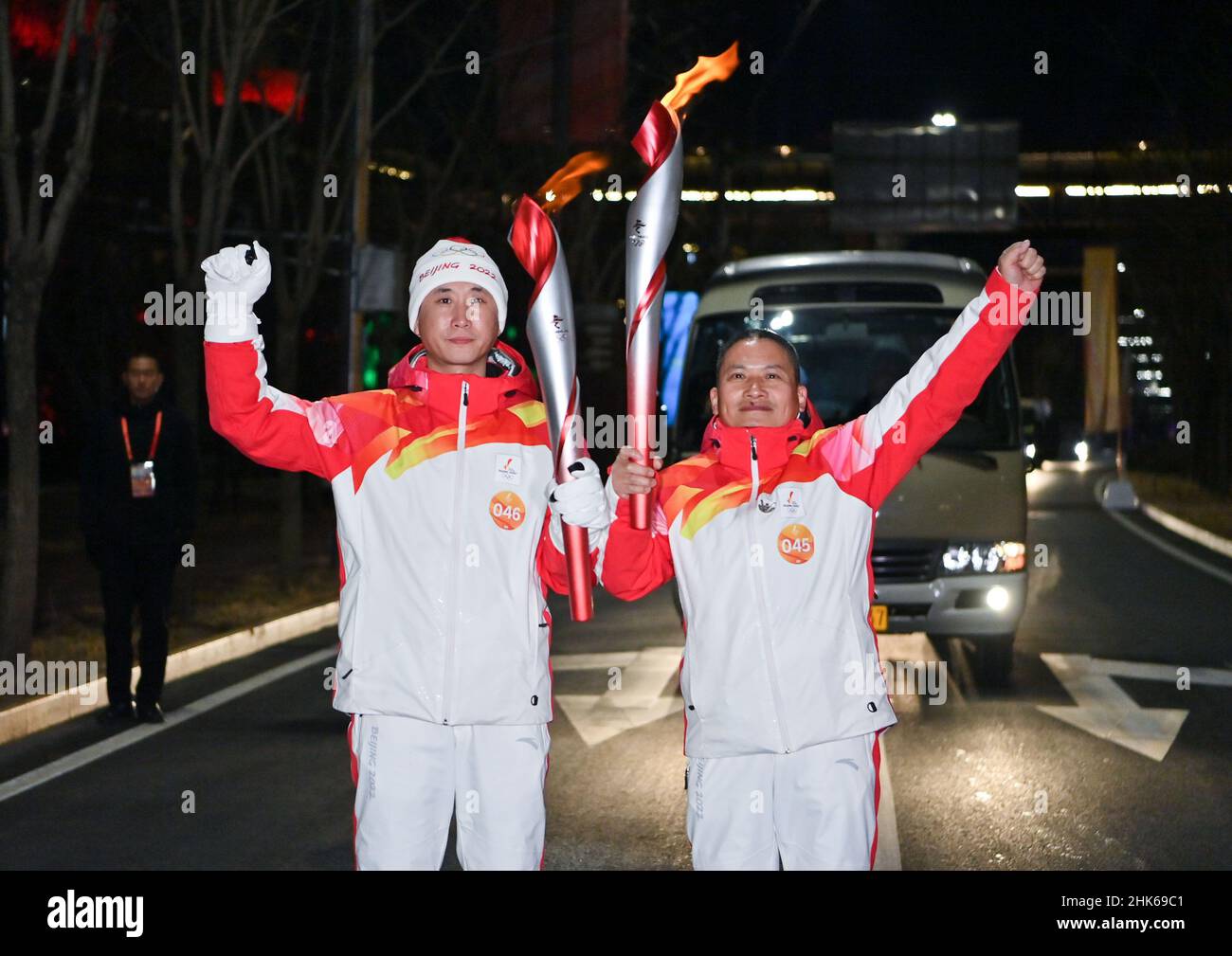 Beijing, China. 2nd Feb, 2022. Torch bearers Xie Chunlong (L) and Qiu ...
