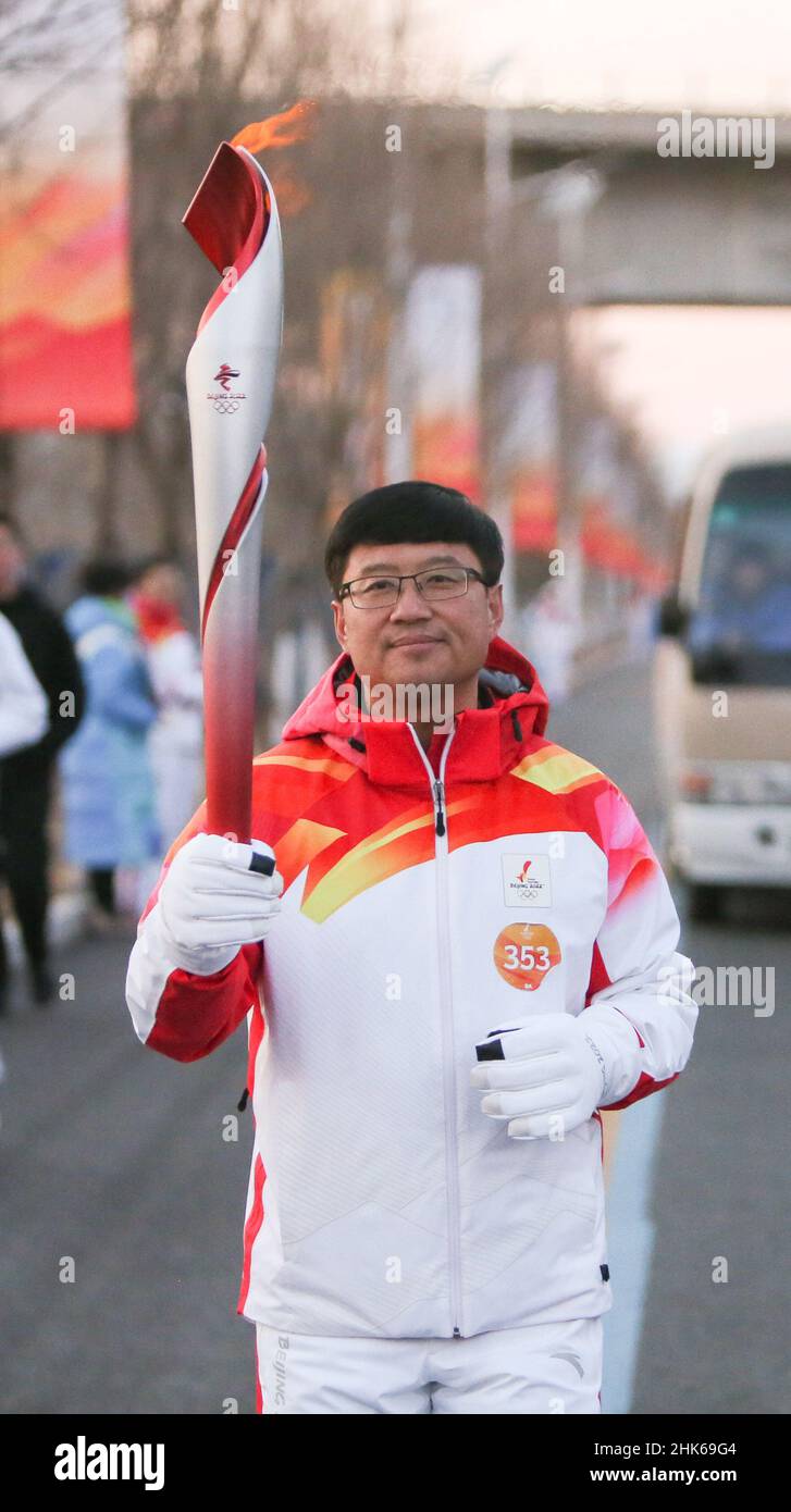 Beijing, China. 2nd Feb, 2022. Torch bearer Yu Deli runs with the torch during the Beijing 2022 ...