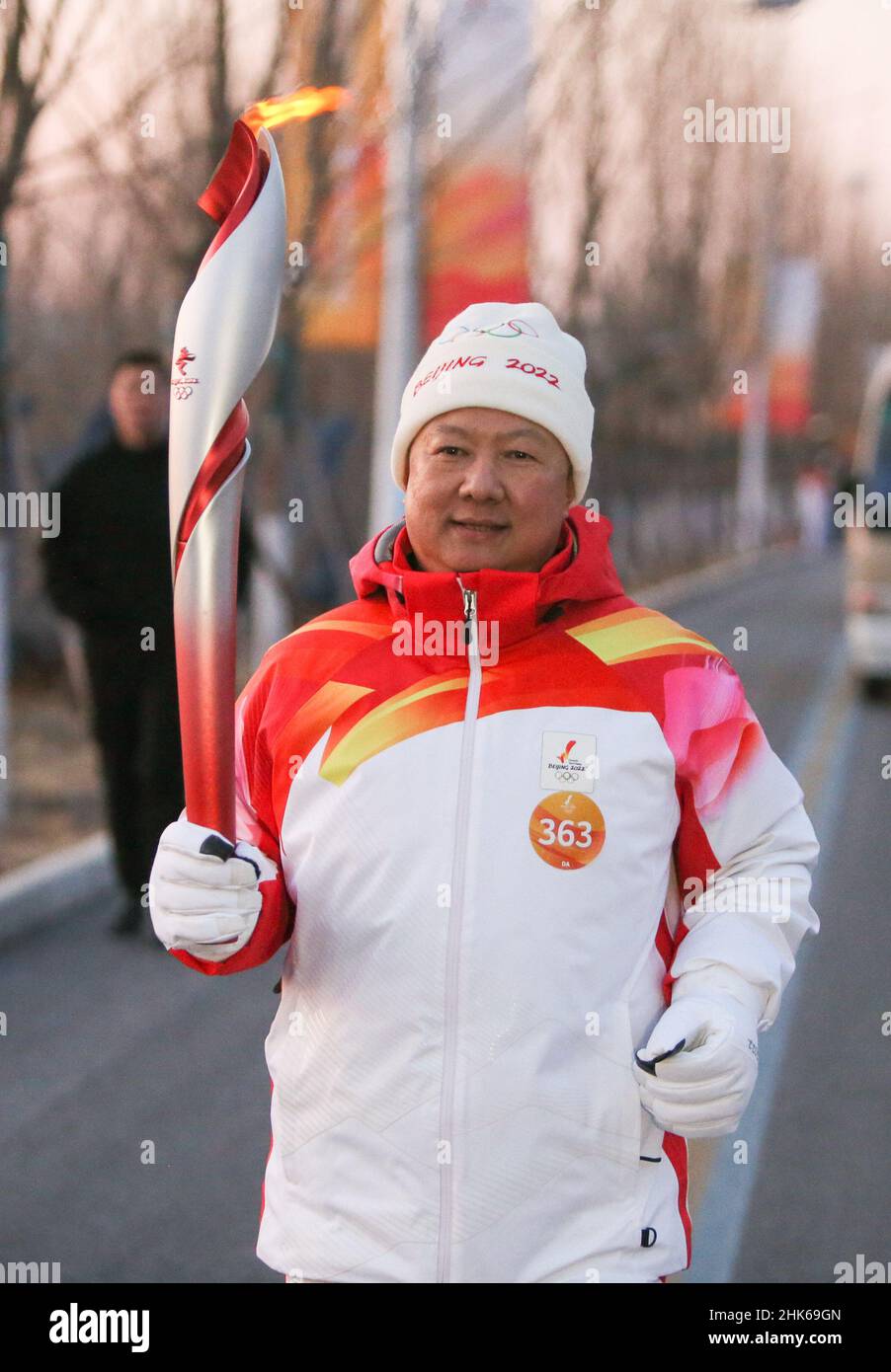 Beijing, China. 2nd Feb, 2022. Torch bearer Zhang Ku runs with the torch during the Beijing 2022 ...