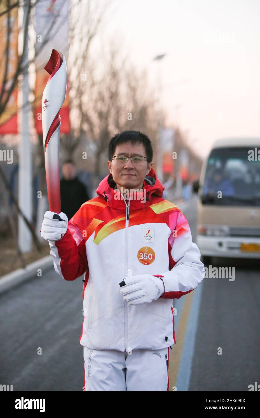Beijing, China. 2nd Feb, 2022. Torch bearer Yang Xiaoou runs with the torch during the Beijing ...