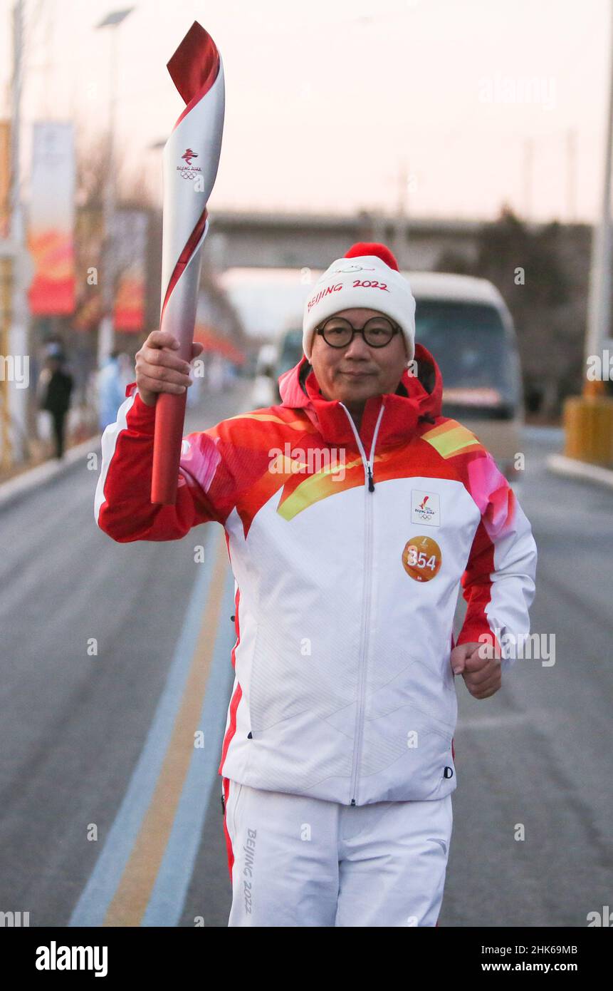 Beijing, China. 2nd Feb, 2022. Torch bearer Yuan Yue runs with the torch during the Beijing 2022 ...