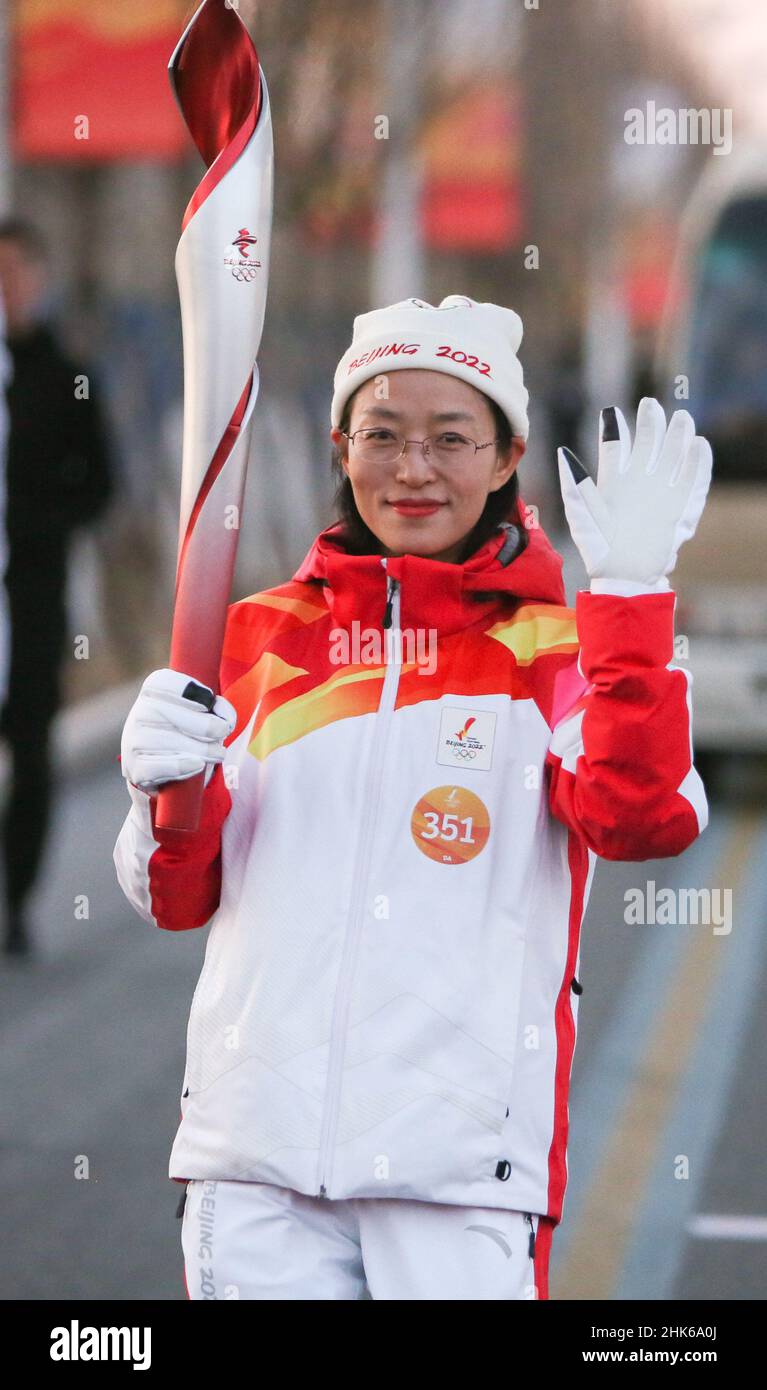 Beijing, China. 2nd Feb, 2022. Torch bearer Yang Xueli runs with the ...