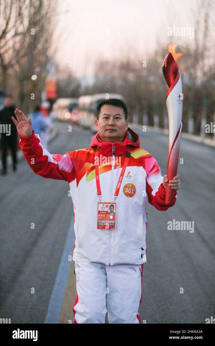 Beijing, China. 2nd Feb, 2022. Torch bearer Zhang Jinfang runs with the torch during the Beijing ...